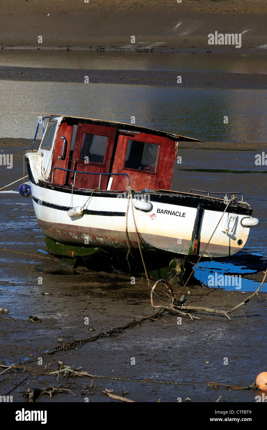A boat 'stuck in the mud' at low tide UK Stock Photo - Alamy