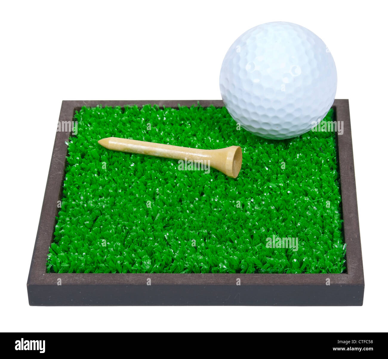 Golf ball and tee laying on the green grass - path included Stock Photo ...
