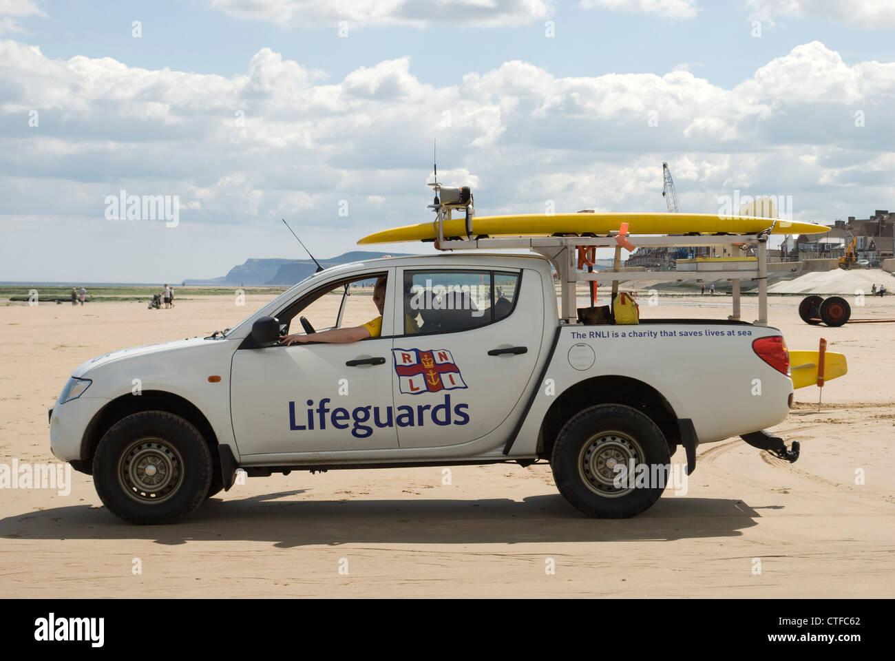 RNLI Lifeguards surveying the coast from their van Stock Photo - Alamy