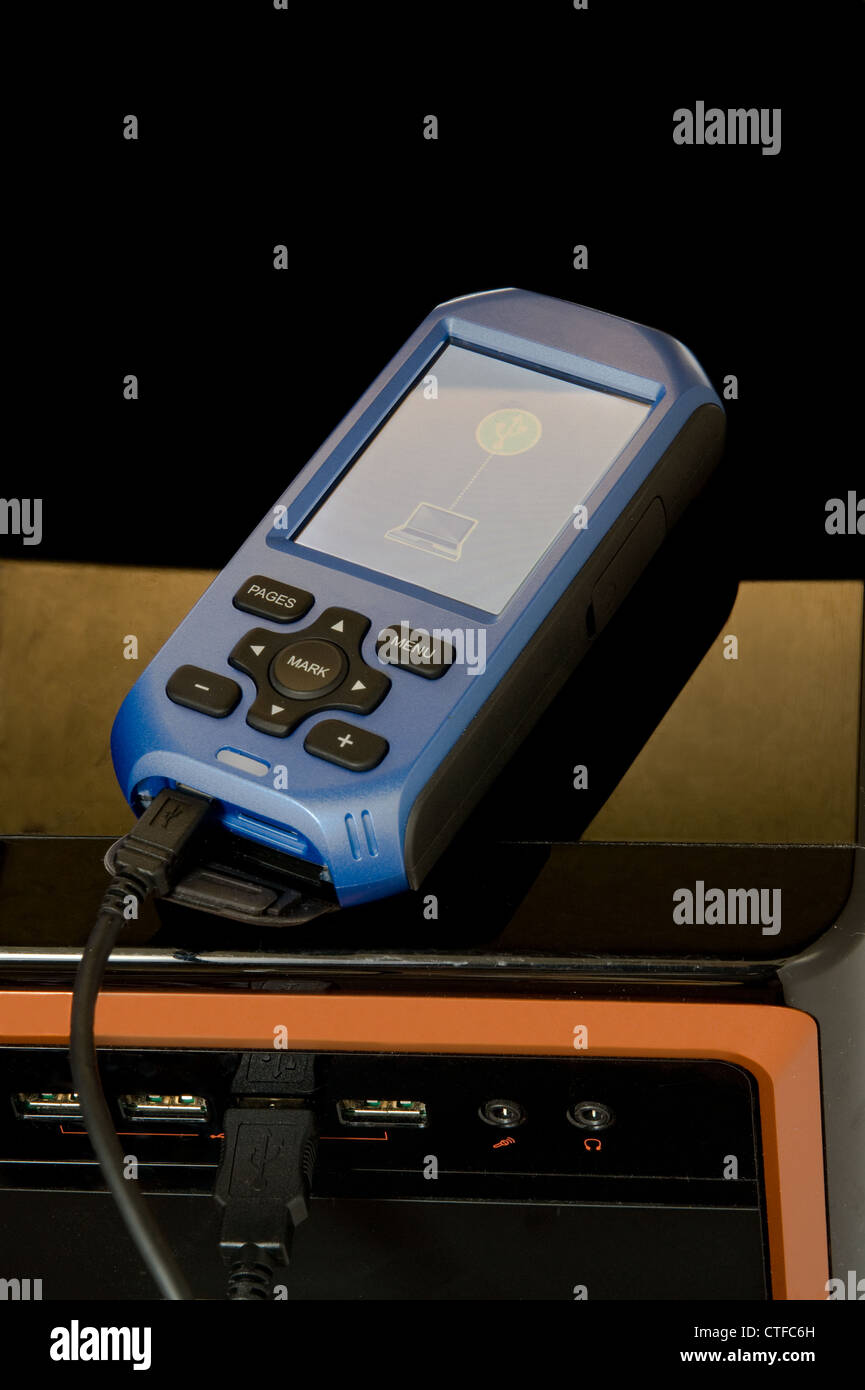 A GPS unit is connected via USB cable to a computer Stock Photo - Alamy