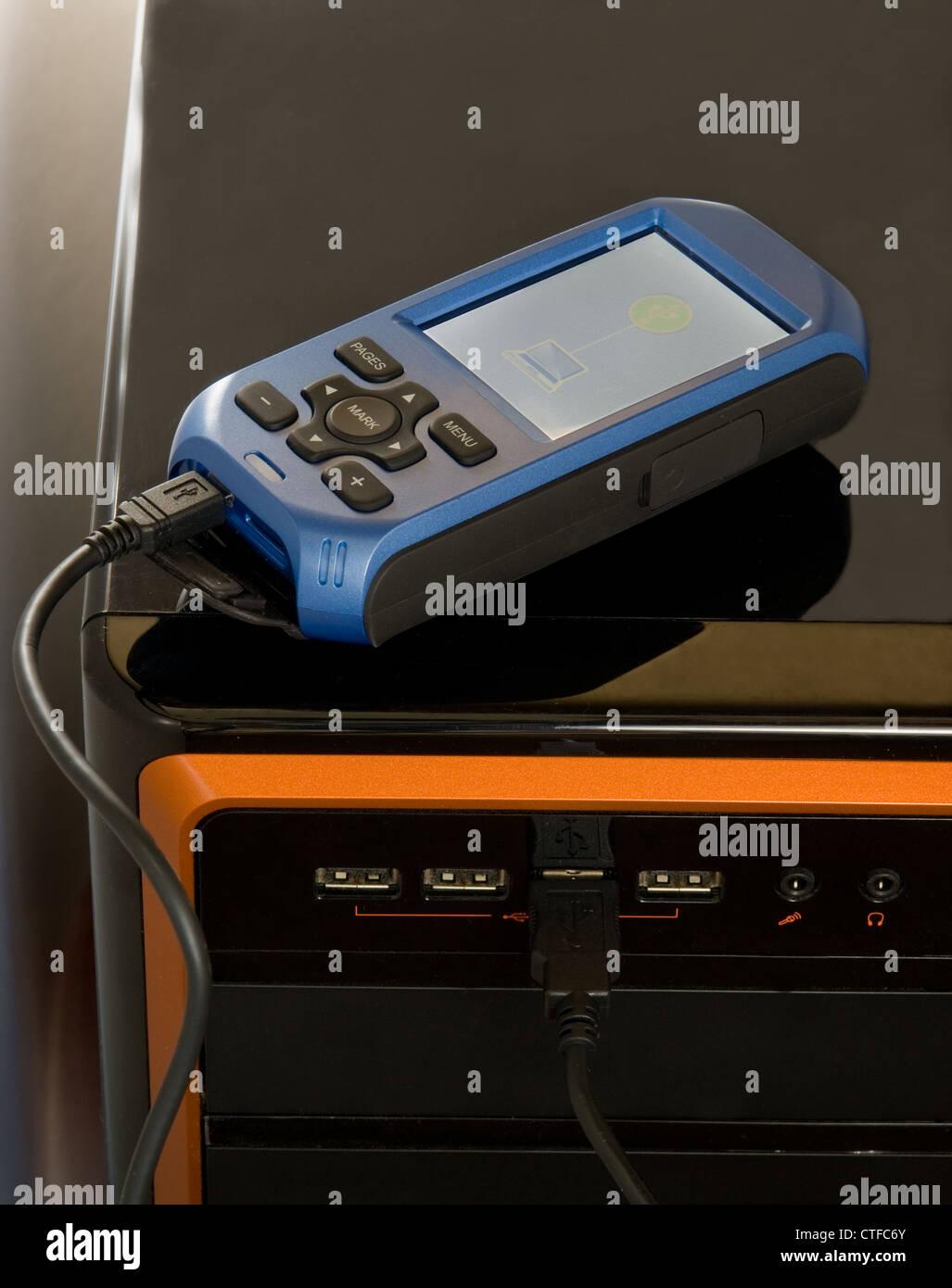 A GPS unit is connected via USB cable to a computer Stock Photo - Alamy