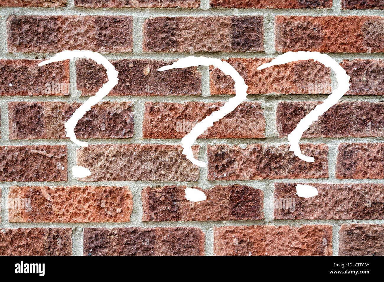 Brick wall with three question marks written on it Stock Photo - Alamy