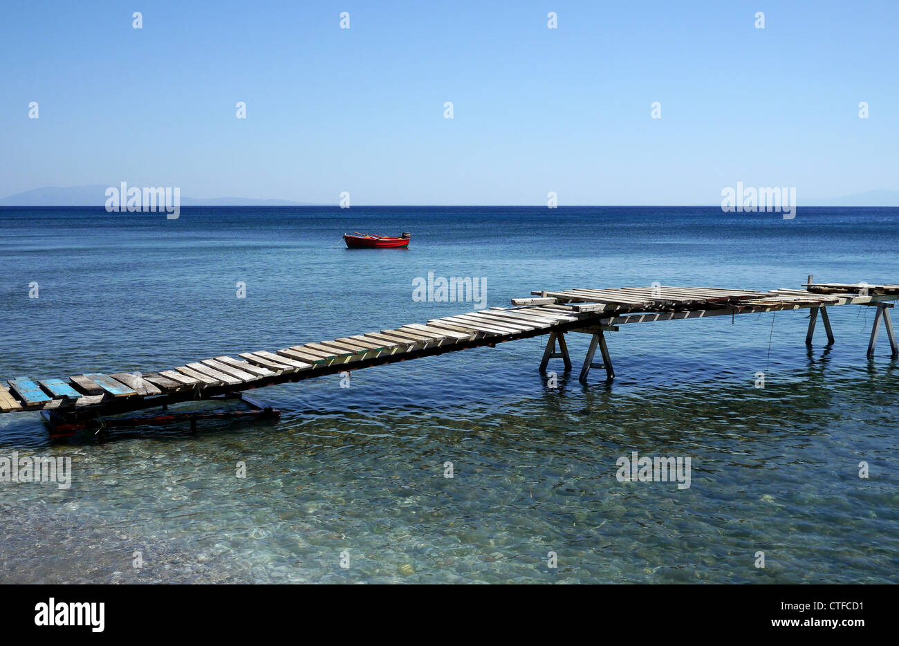 small boat and rustic jetty in greece Stock Photo - Alamy