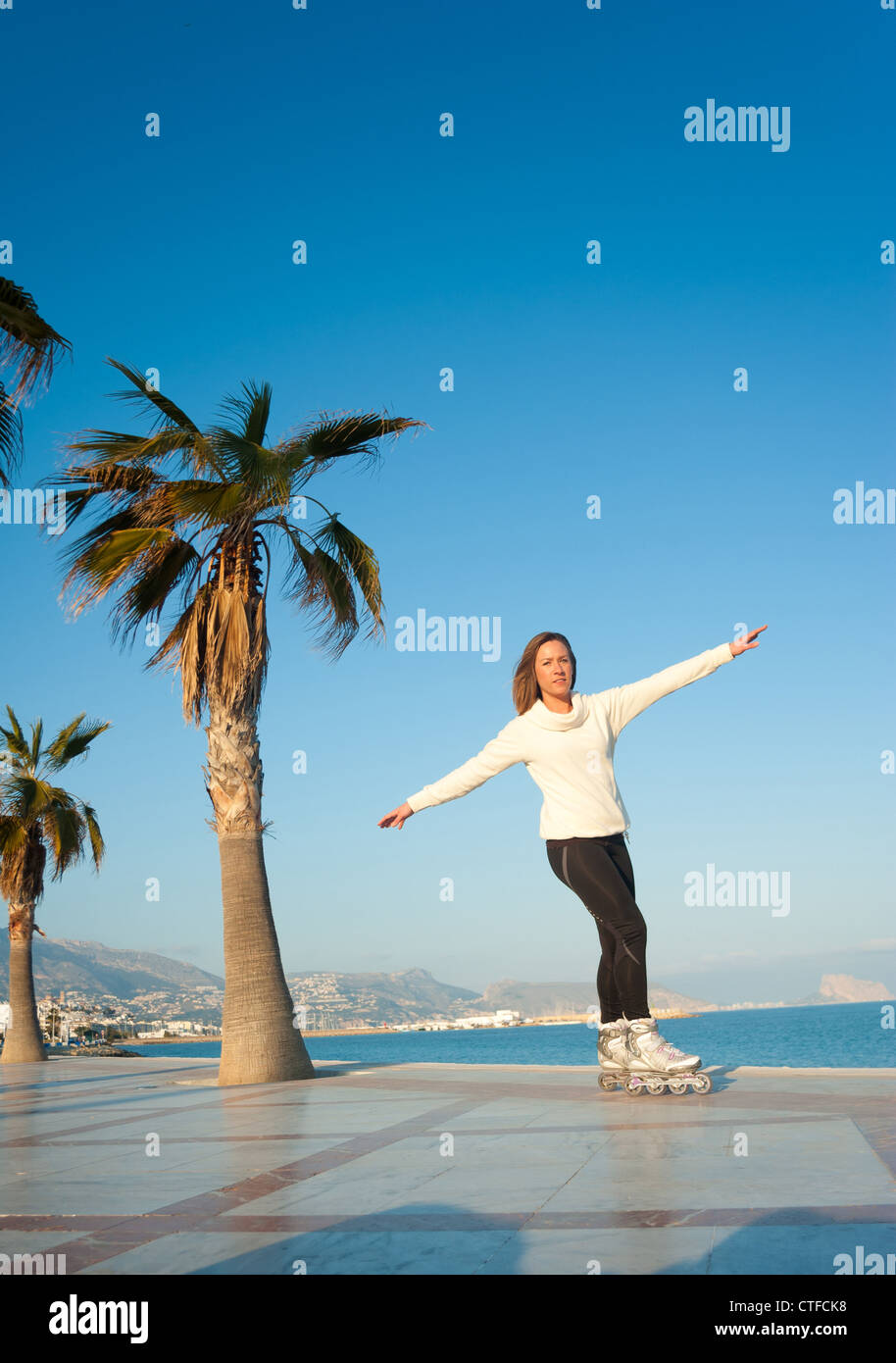Having fun skating on a sunny Mediterranean beach promenade Stock Photo ...