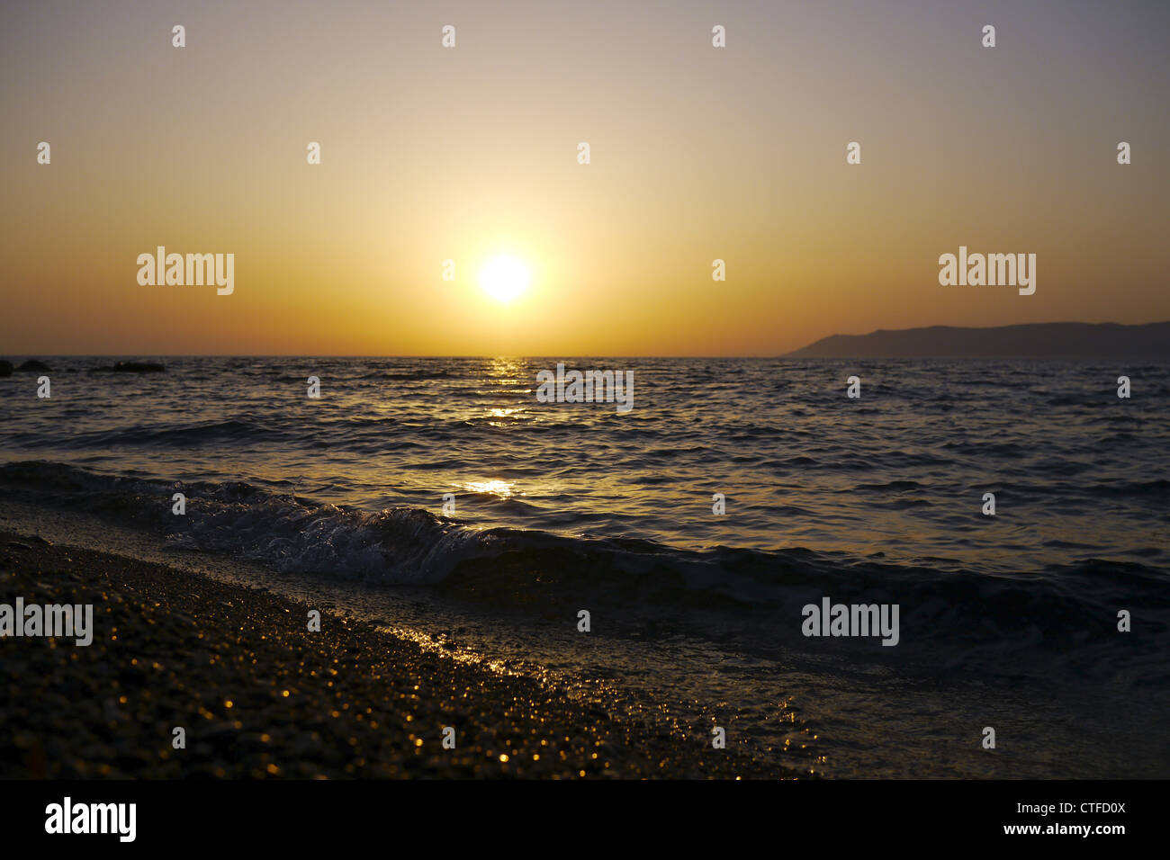 perfect sunset over aegean ocean Stock Photo - Alamy