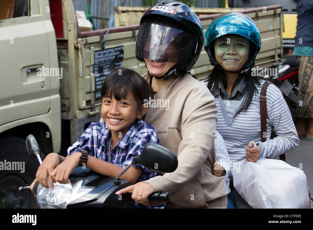 Motorbike rider and passengers, Bali Stock Photo - Alamy