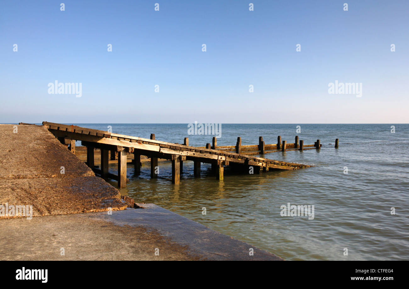 Seawall with slipway to the beach and sea at Walcott, Norfolk, England ...