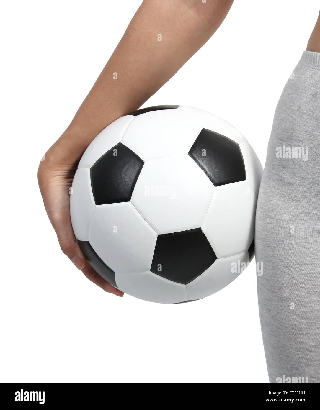 Closeup image of woman holding a football in right hand beside her body ...