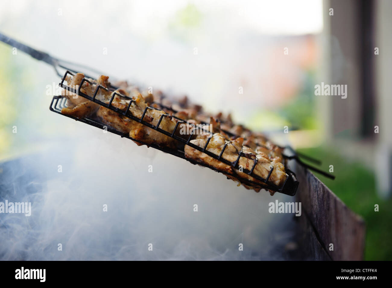 Barbecue with chicken in metal grate hi-res stock photography and ...