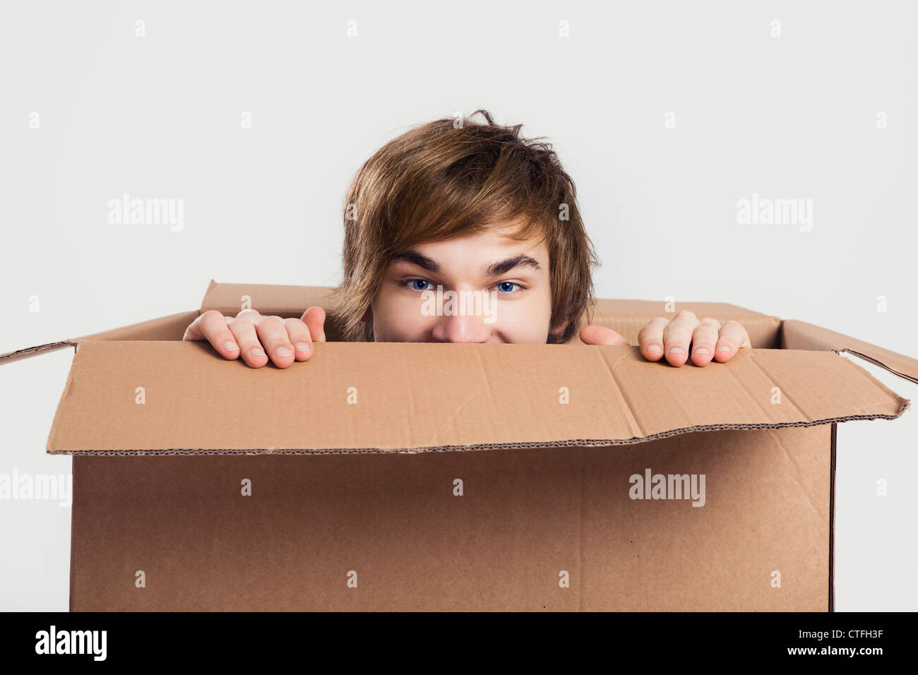 Man hiding inside cardboard box hi-res stock photography and images - Alamy