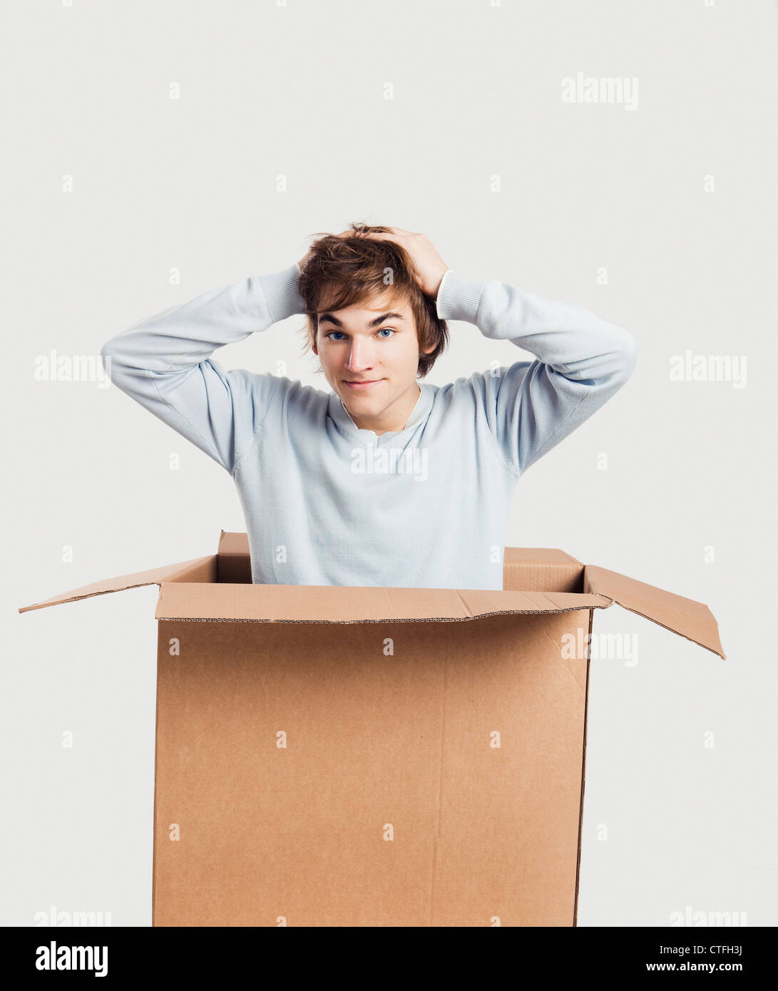 Portrait of a handsome young man inside a card box Stock Photo - Alamy