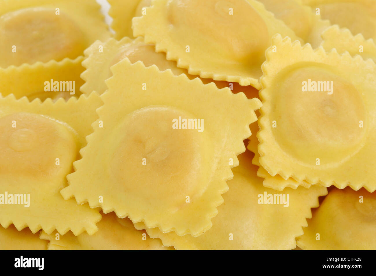 Dry ravioli pasta on white background Stock Photo - Alamy