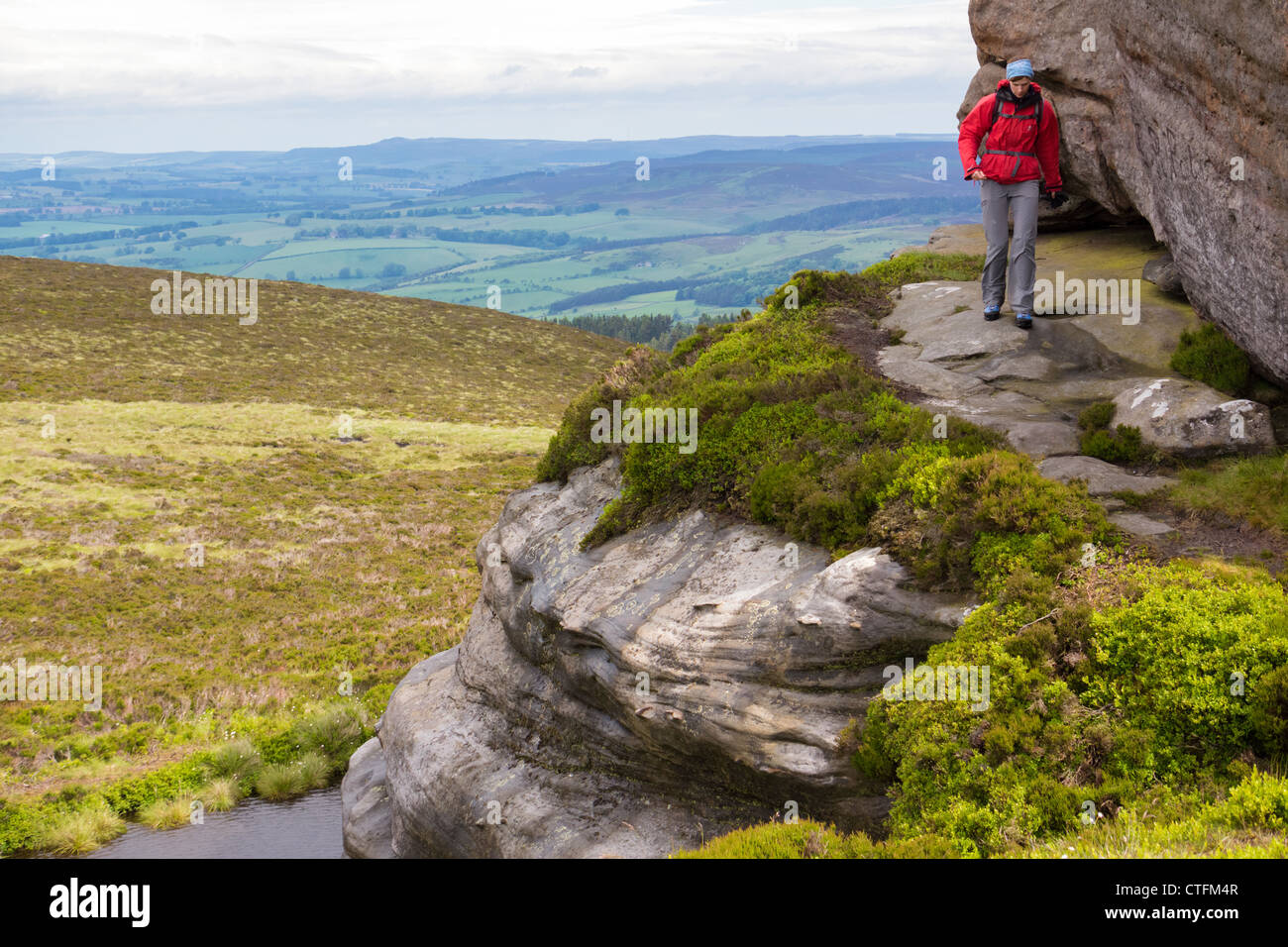 A hiker explorers the different climbing routes and views around ...