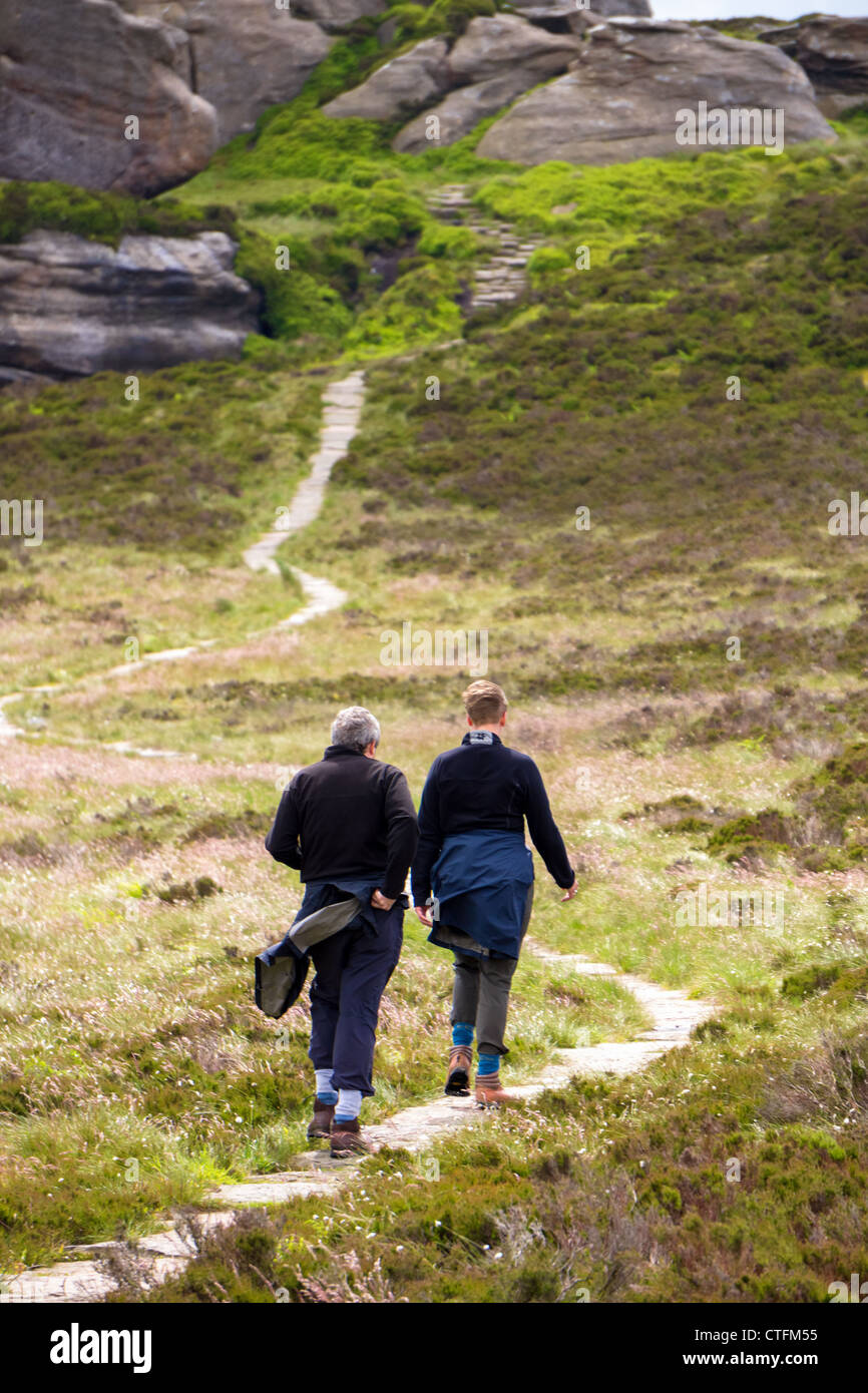 Two hikers making their way over the tops of Simonside Hills near ...