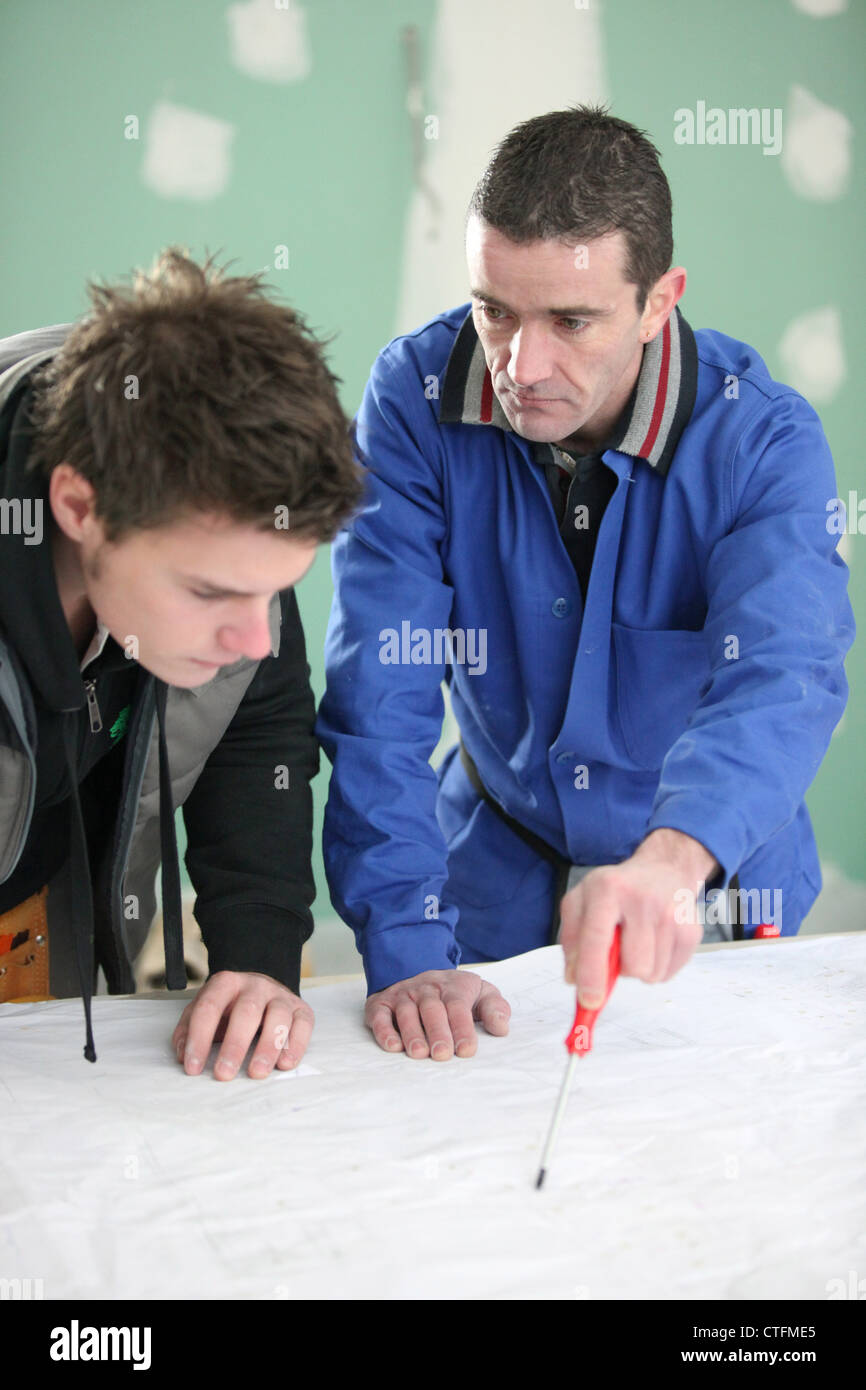 Builder and his apprentice Stock Photo - Alamy