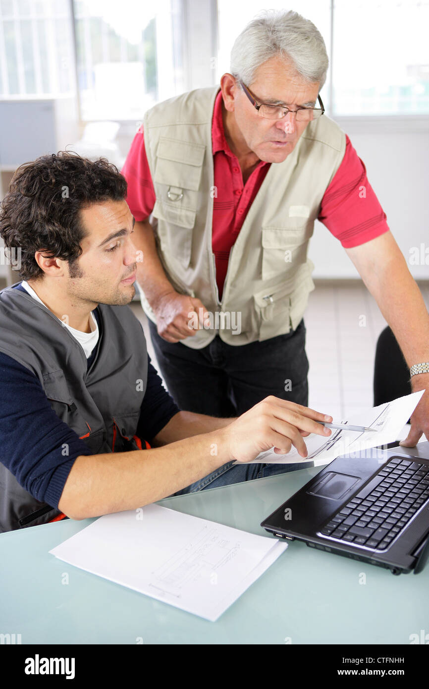 Worker going through some paperwork Stock Photo - Alamy