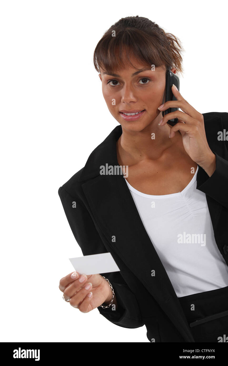 Woman calling number on business card Stock Photo - Alamy