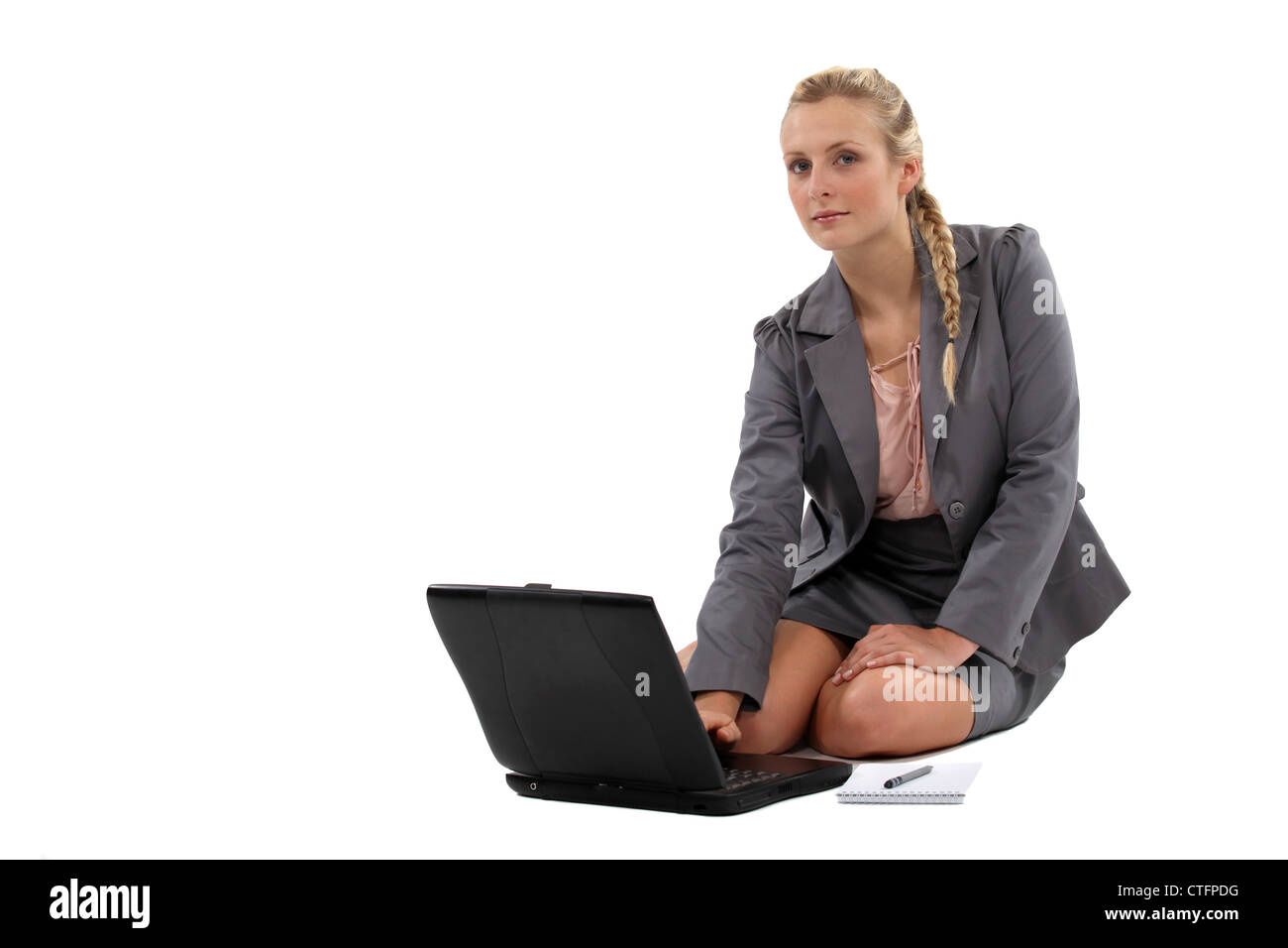 Businesswoman sitting on the floor with laptop Stock Photo - Alamy