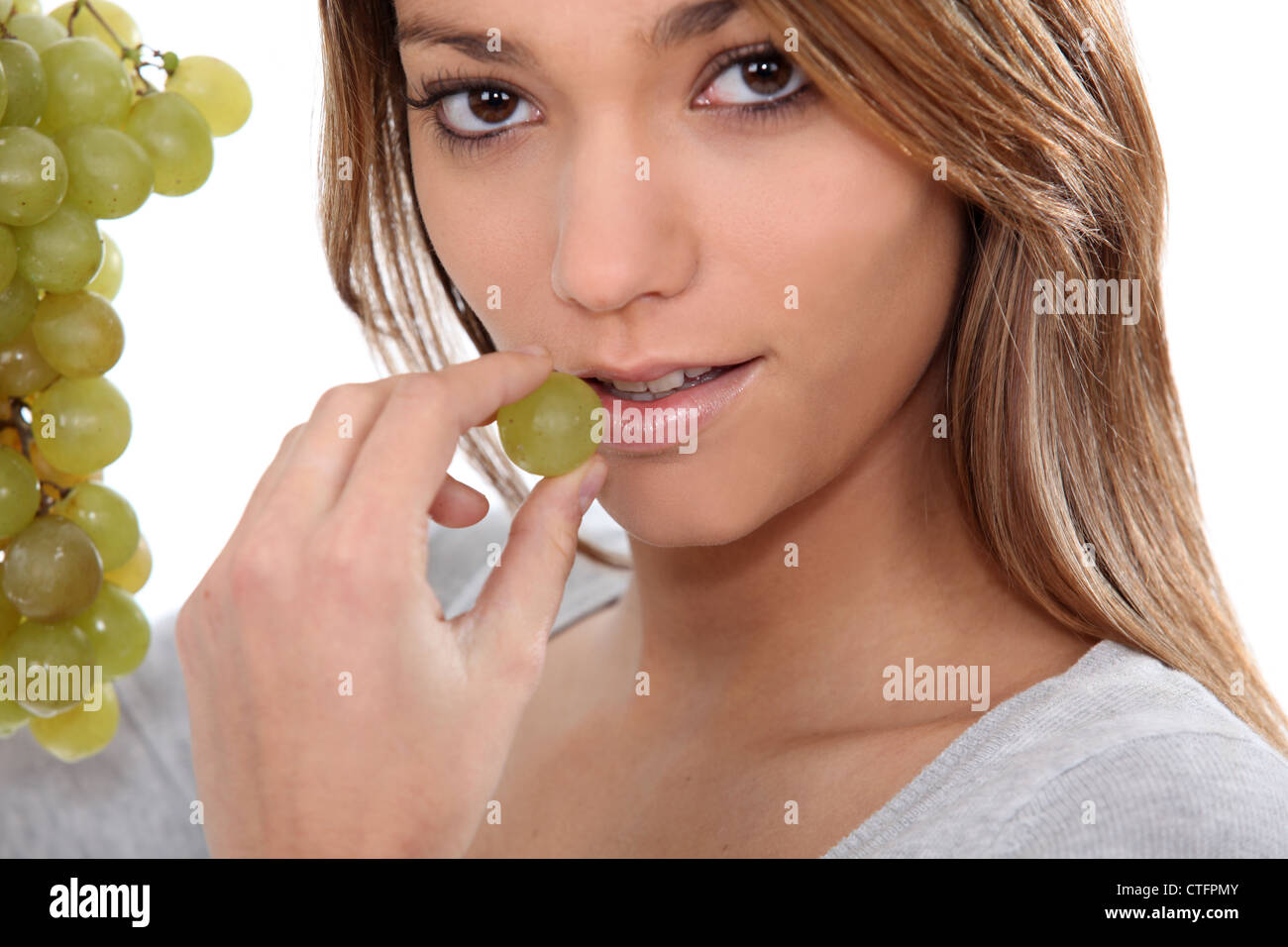 young woman eating grapes Stock Photo - Alamy