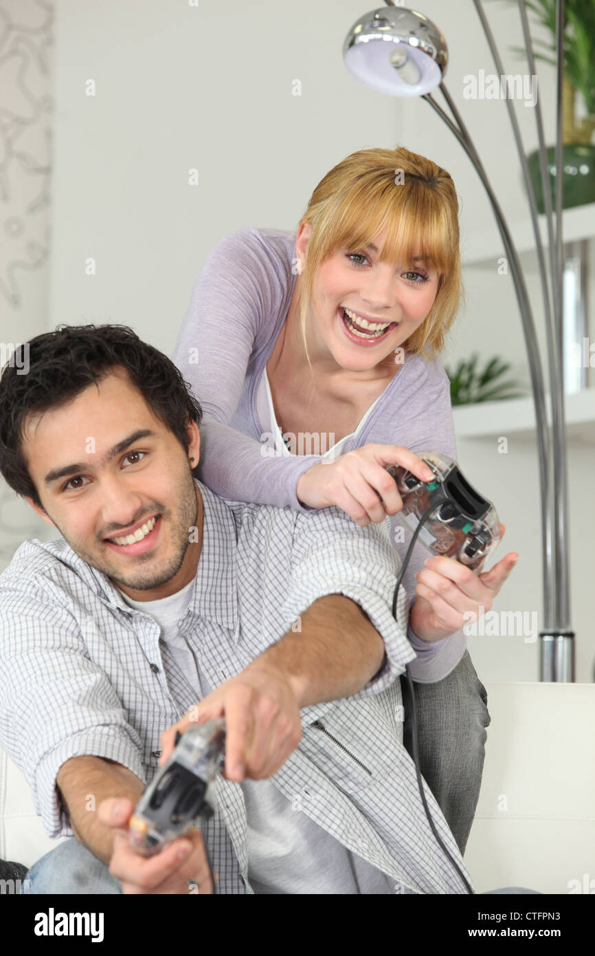 Young woman and young man playing video games Stock Photo - Alamy