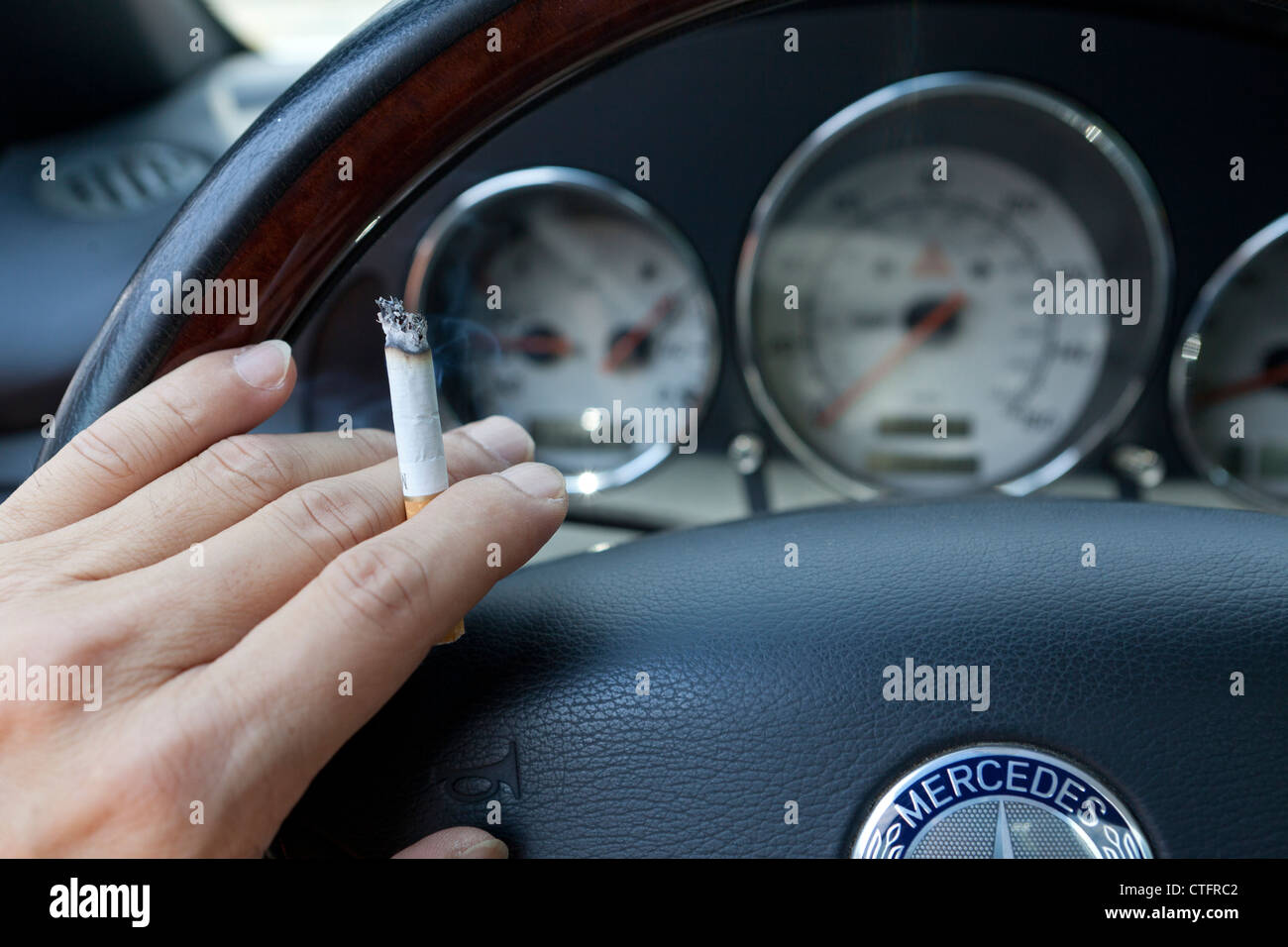 Smoking while driving Stock Photo - Alamy