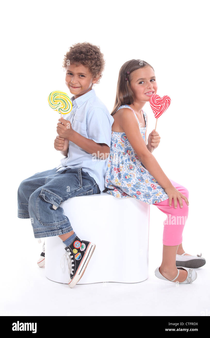 Two children with lollipops Stock Photo - Alamy
