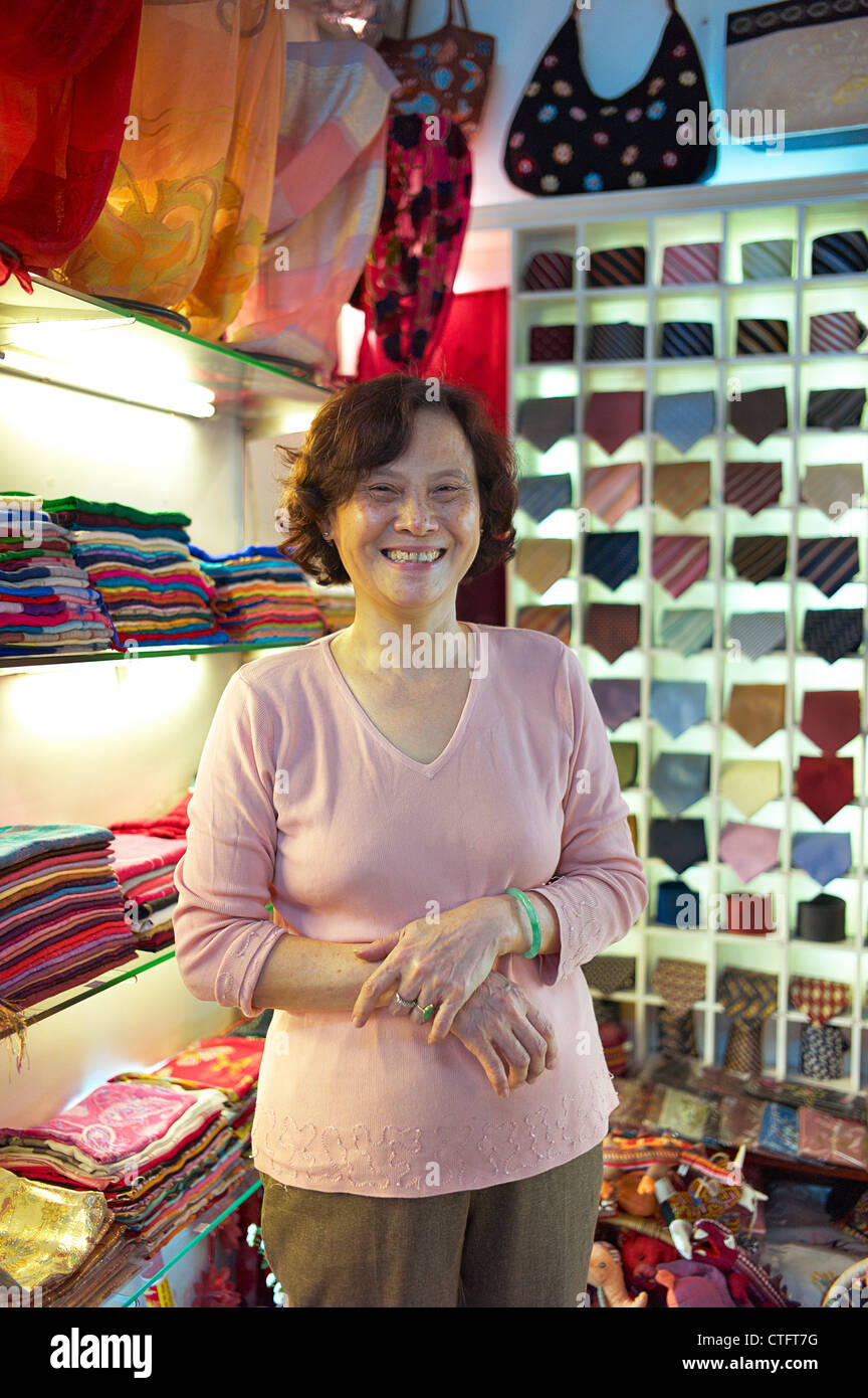 A shop owner shows off silk at the Nunal Boutique silk shop in Hanoi ...