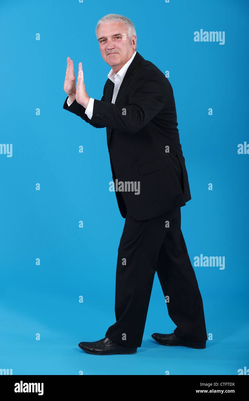 A businessman making a push gesture Stock Photo - Alamy