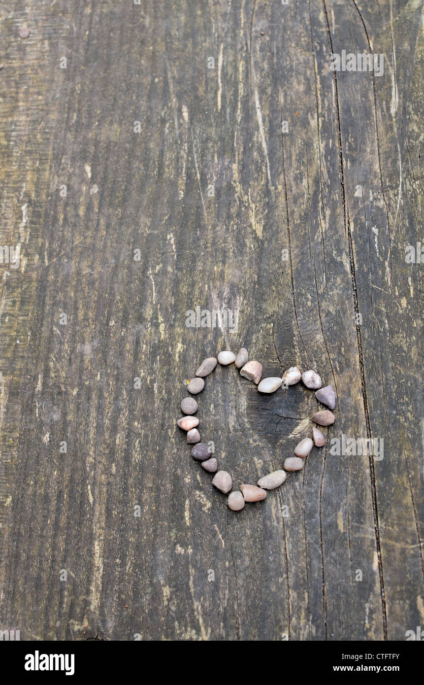 Heart shape made of pebbles on a weathered wooden plank Stock Photo - Alamy