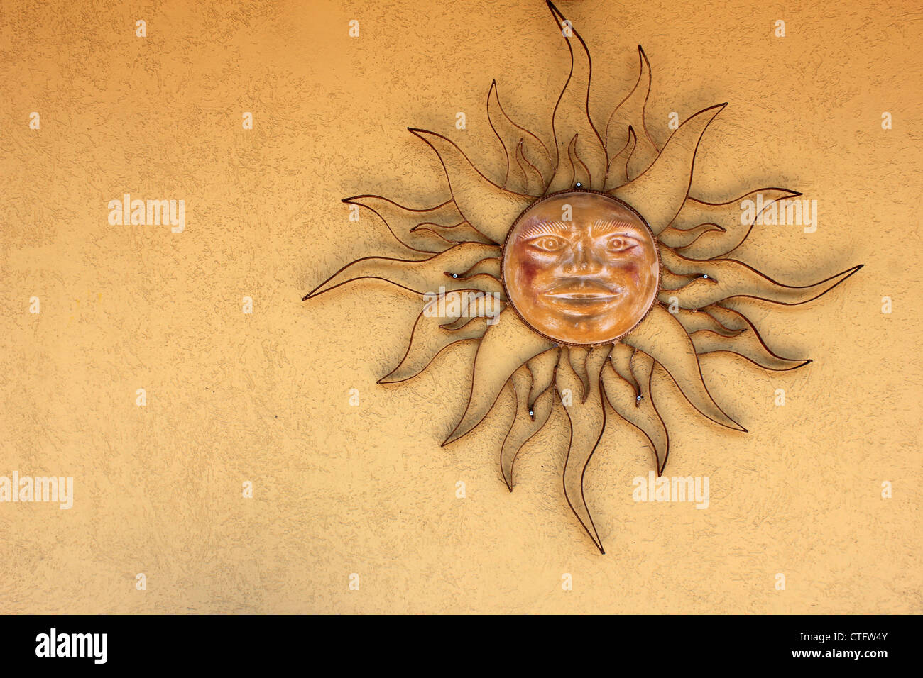Large metal face of sun with rays of hope and positivity that reach out ...