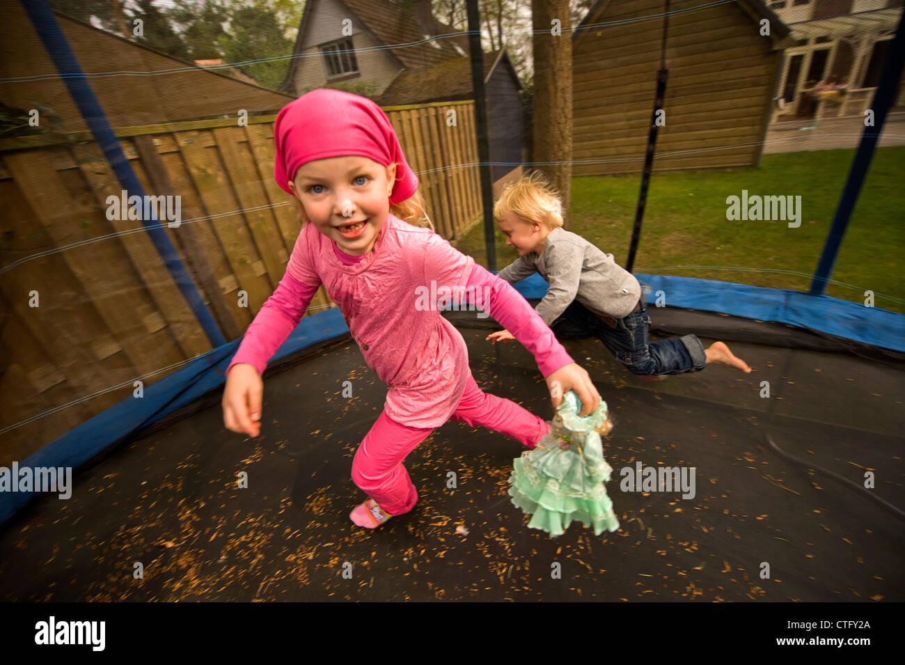 Kids playing pink trampoline hi-res stock photography and images - Alamy