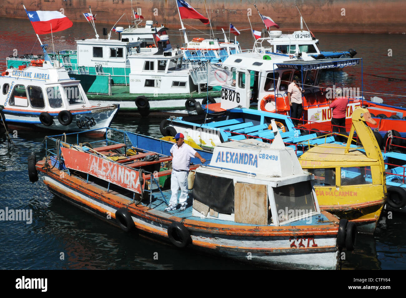 Various colourful tourist boats, with owners, docks, Valparaiso, Chile ...