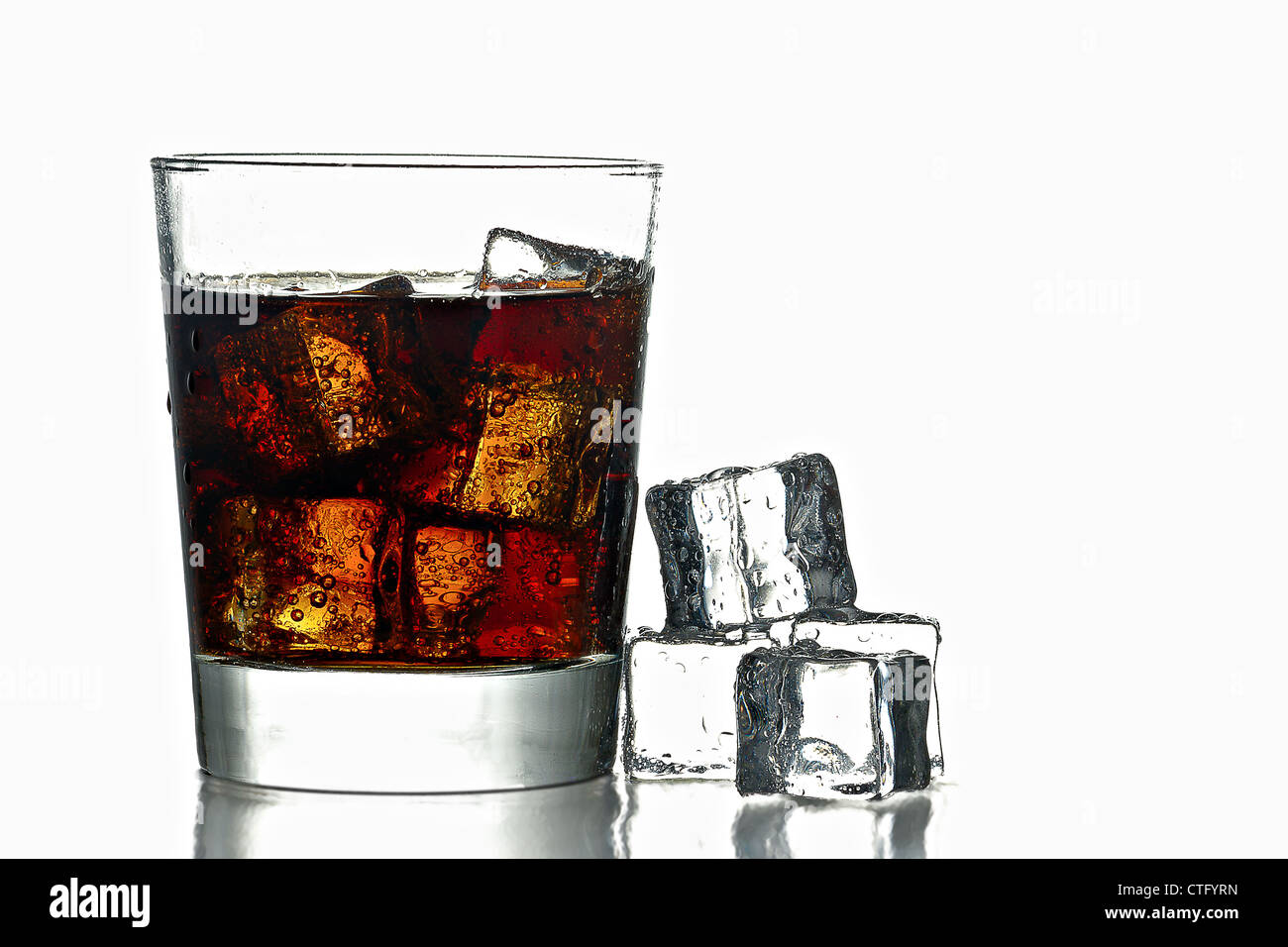 glass of fresh icy cold cola with ice cubes next to Stock Photo - Alamy