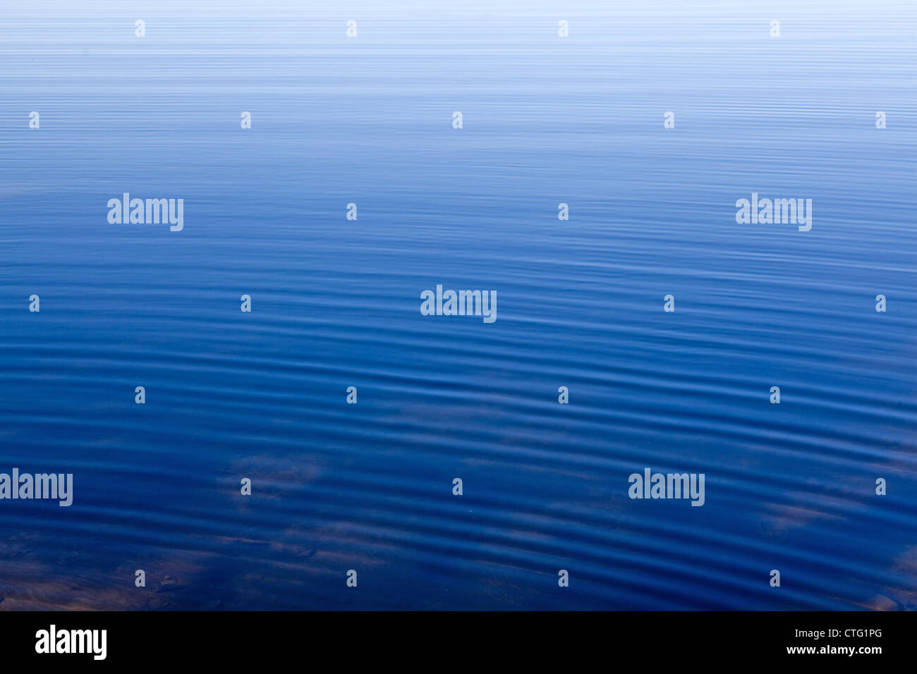 Abstract background dark blue water ripples fading to light blue Stock ...