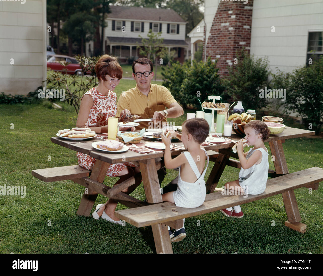 1960s FAMILY OF FOUR AT BACKYARD PICNIC TABLE Stock Photo - Alamy