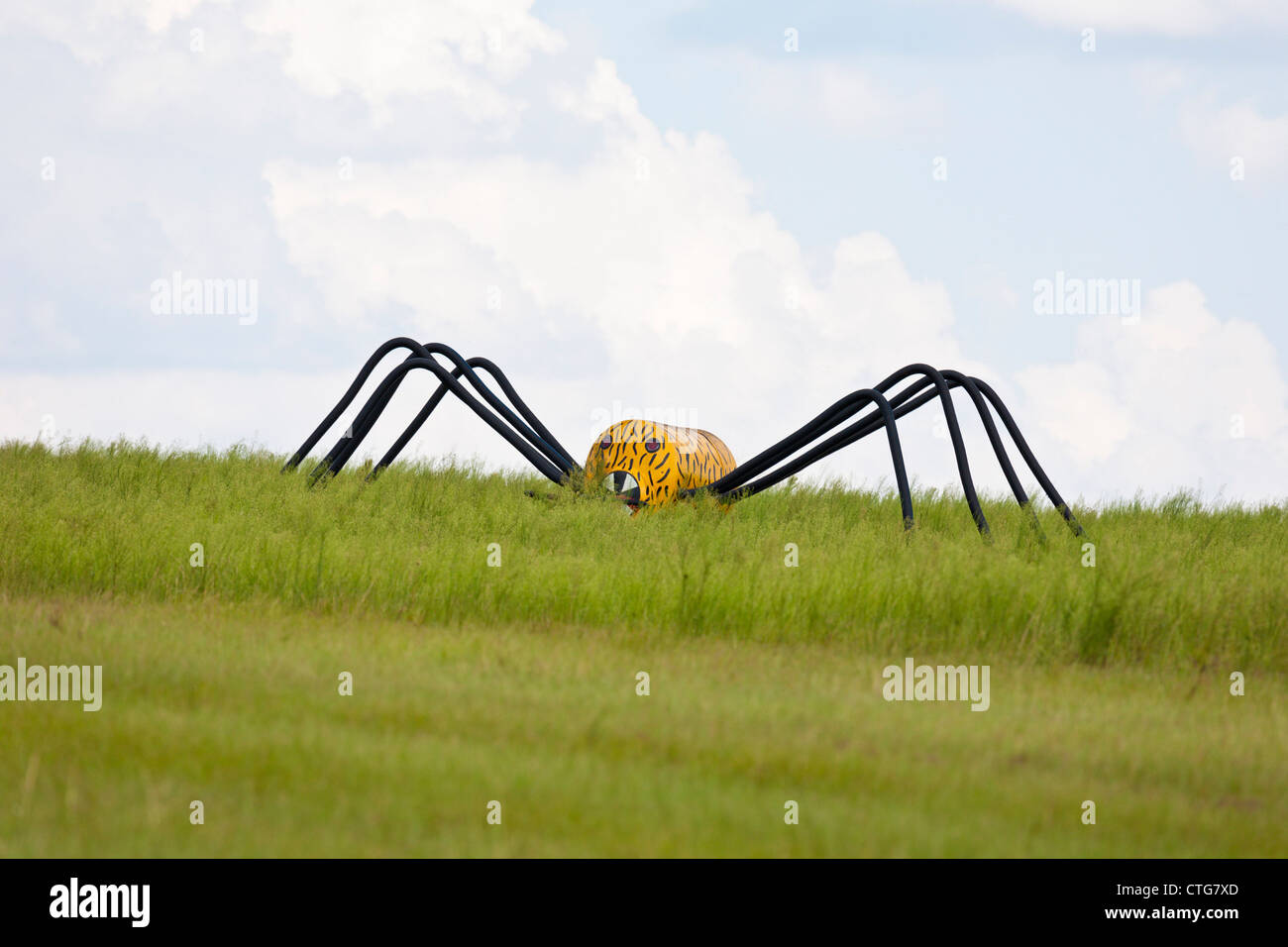 Metal sculpture of large spider made from a tank and steel pipes in an ...