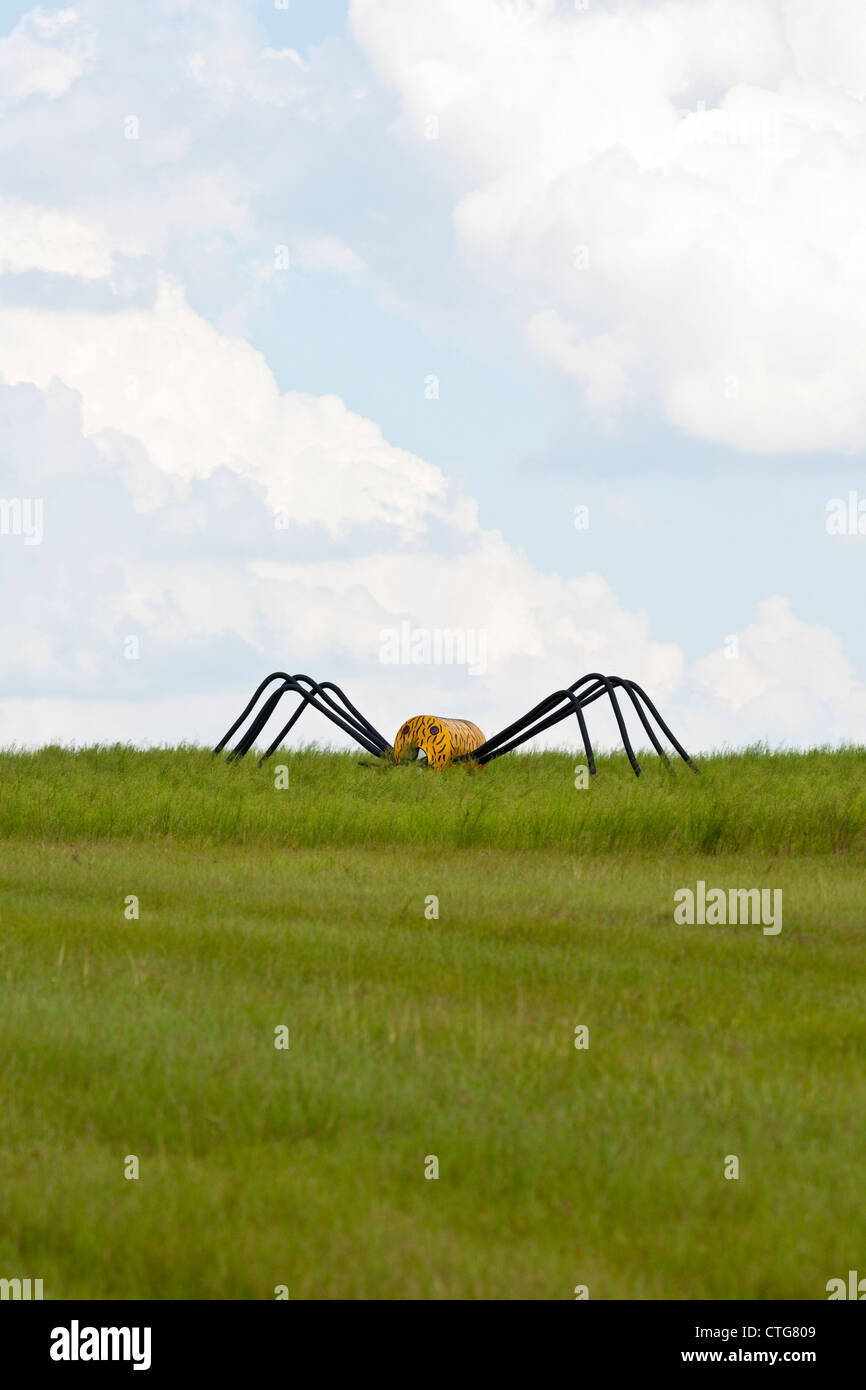 Metal sculpture of large spider made from a tank and steel pipes in an ...