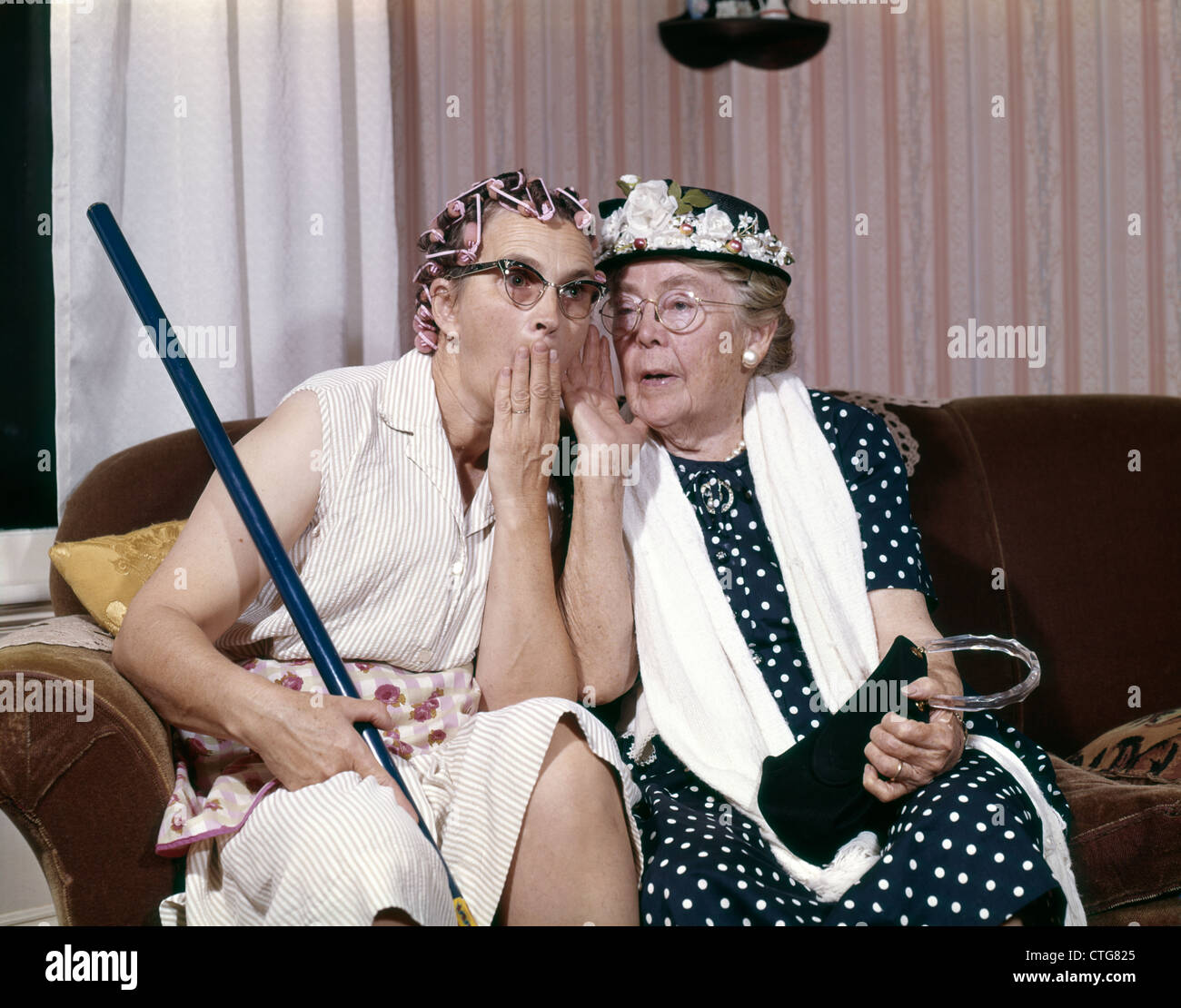 1960s TWO SENIOR OLDER WOMEN SITTING ON SOFA GOSSIPING Stock Photo - Alamy
