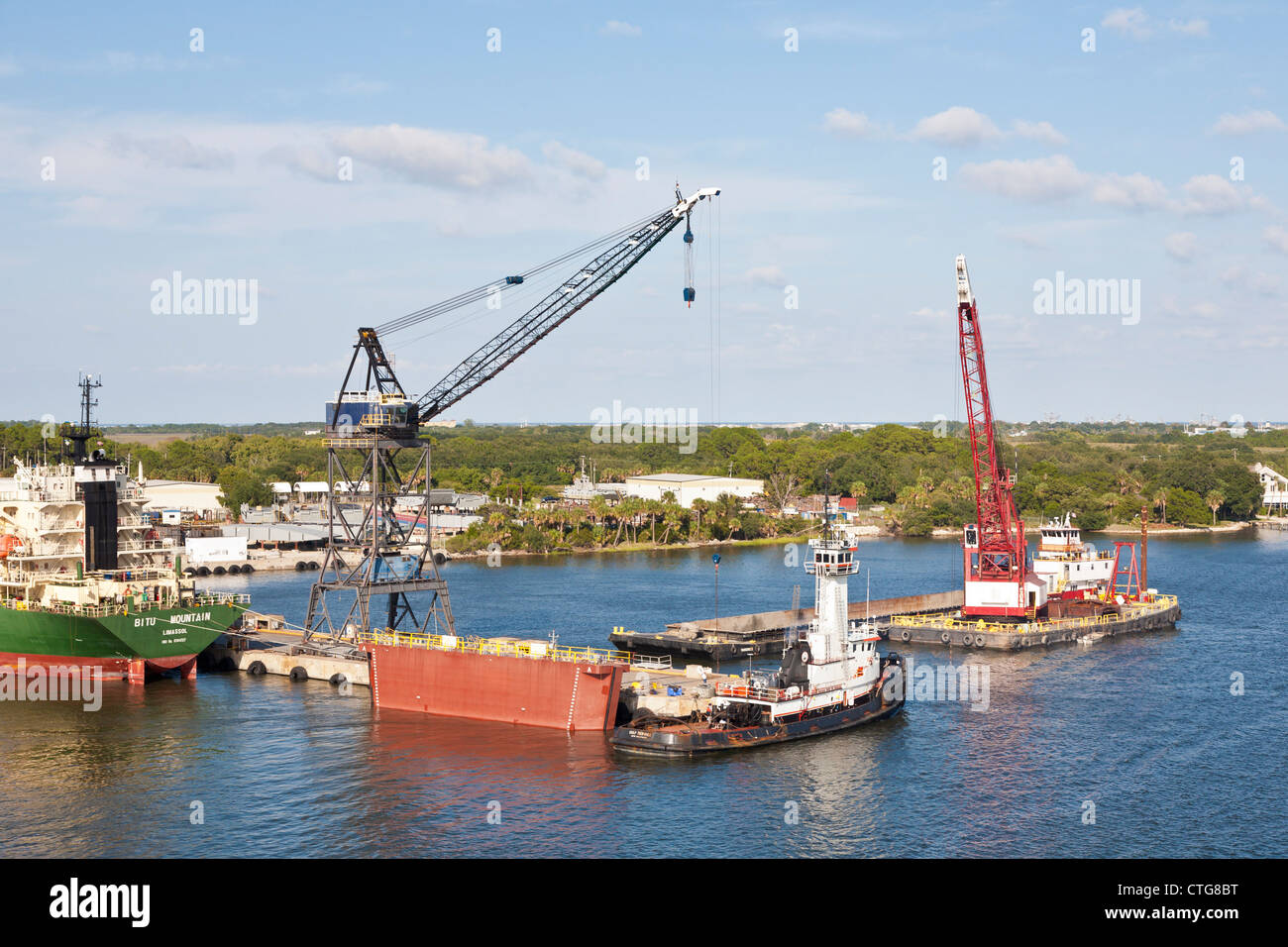 Bitu Mountain, tug boats and a crane barge docked in the St. Johns ...