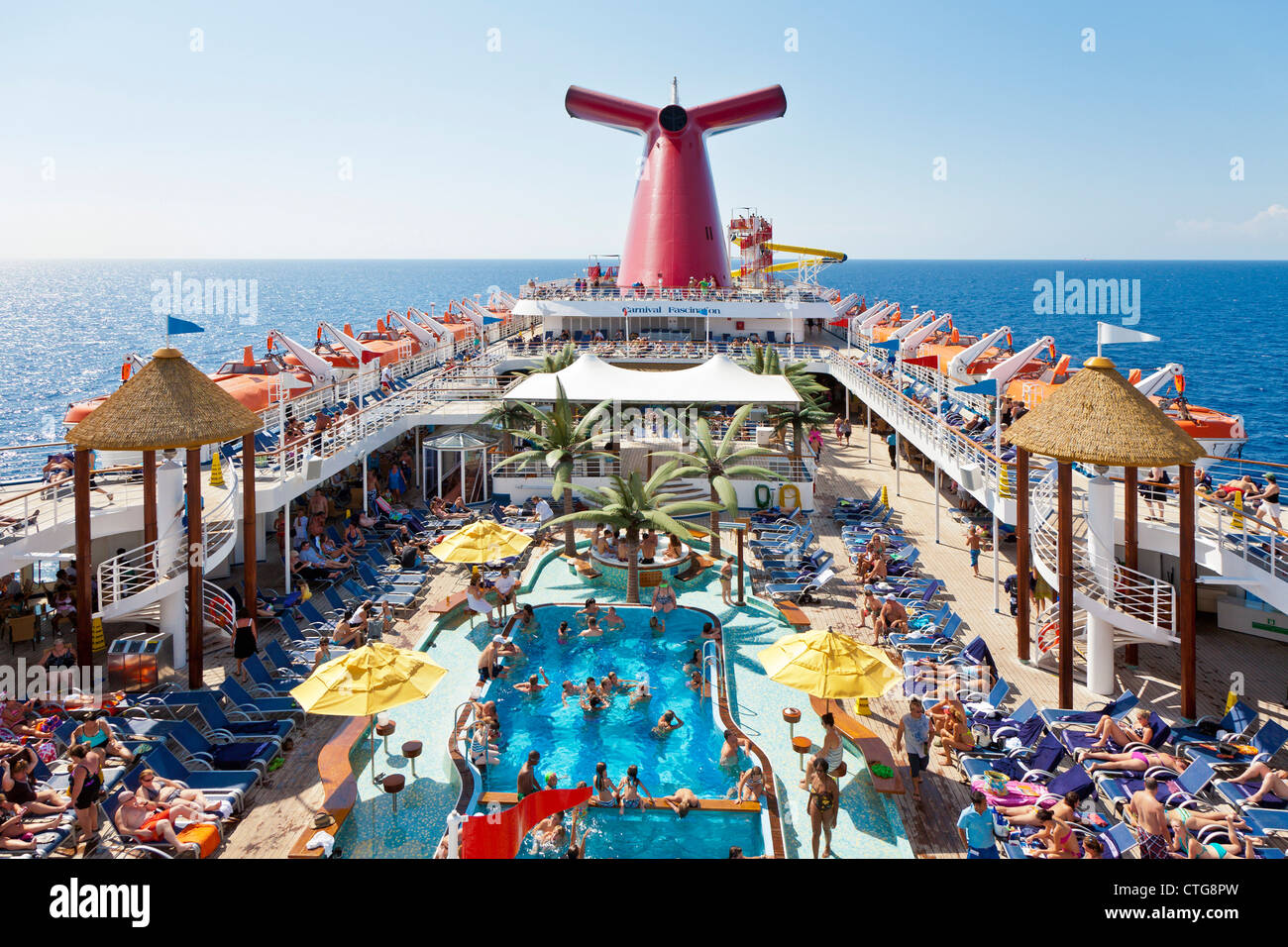 Cruise Passengers Enjoying The Sun On Deck Of Carnival Fascination