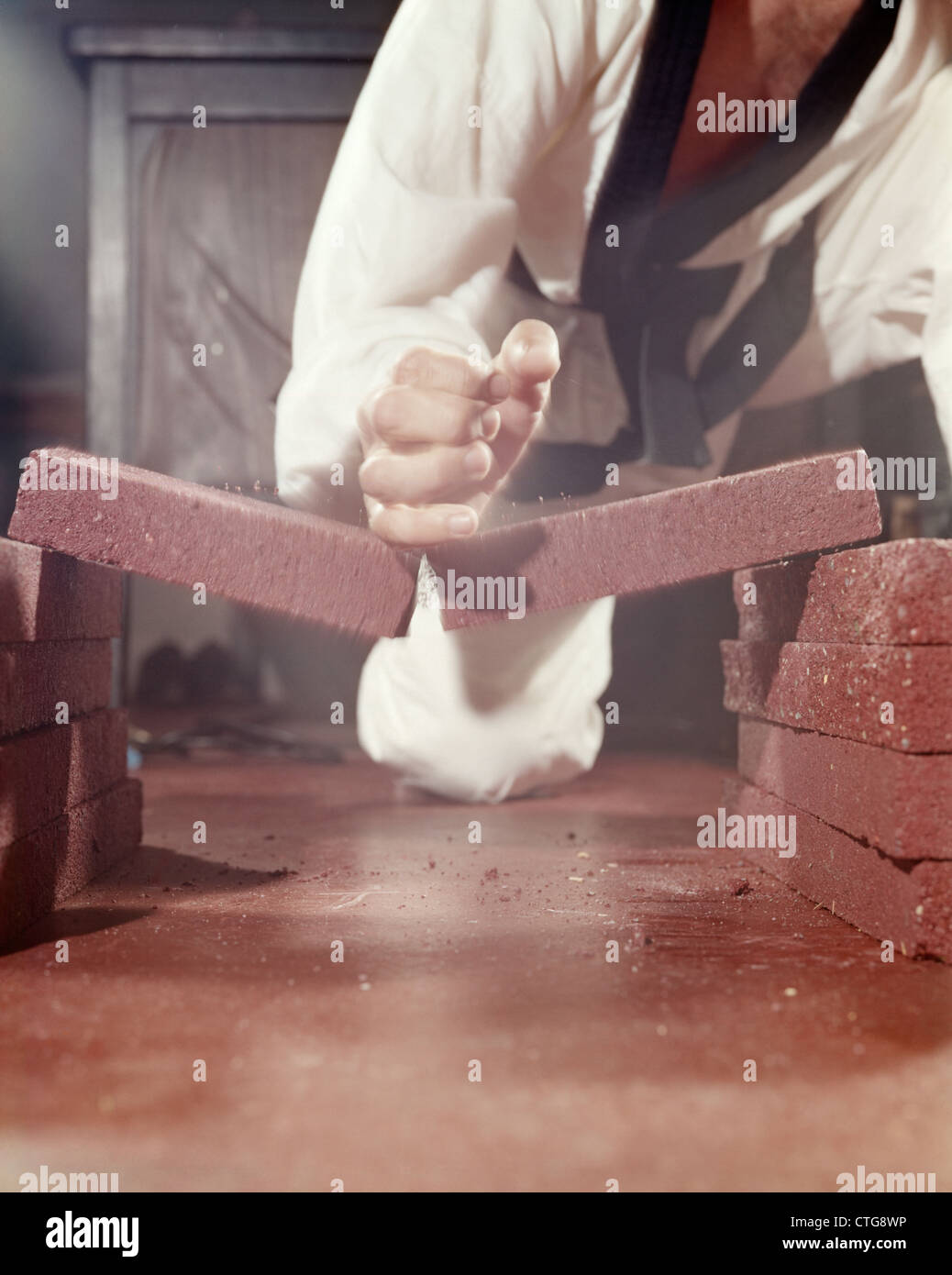 1960s MAN HAND BREAKING BRICK TILE WITH JUDO KARATE CHOP Stock Photo ...