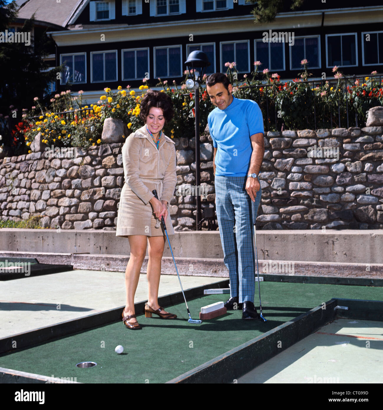 1960s COUPLE MAN WOMAN PLAYING MINIATURE GOLF Stock Photo - Alamy
