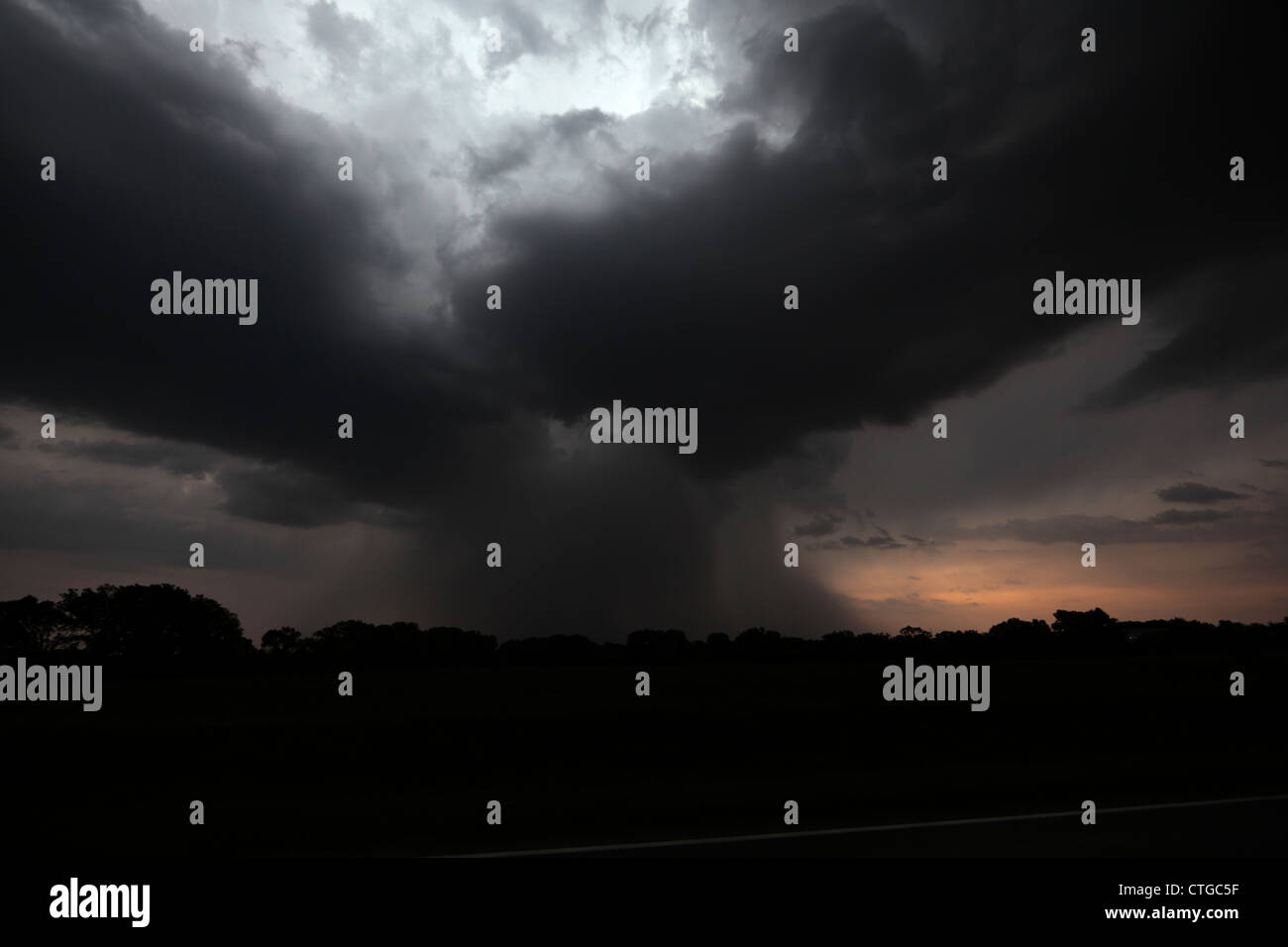 An area of heavy rain between two converging clouds, evening Stock ...