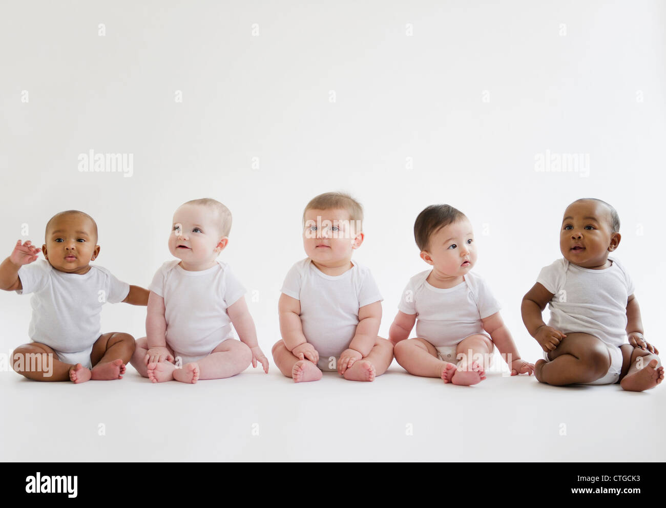 Babies sitting on floor together Stock Photo - Alamy