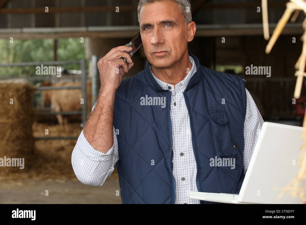 farmer with mobile phone and laptop Stock Photo - Alamy