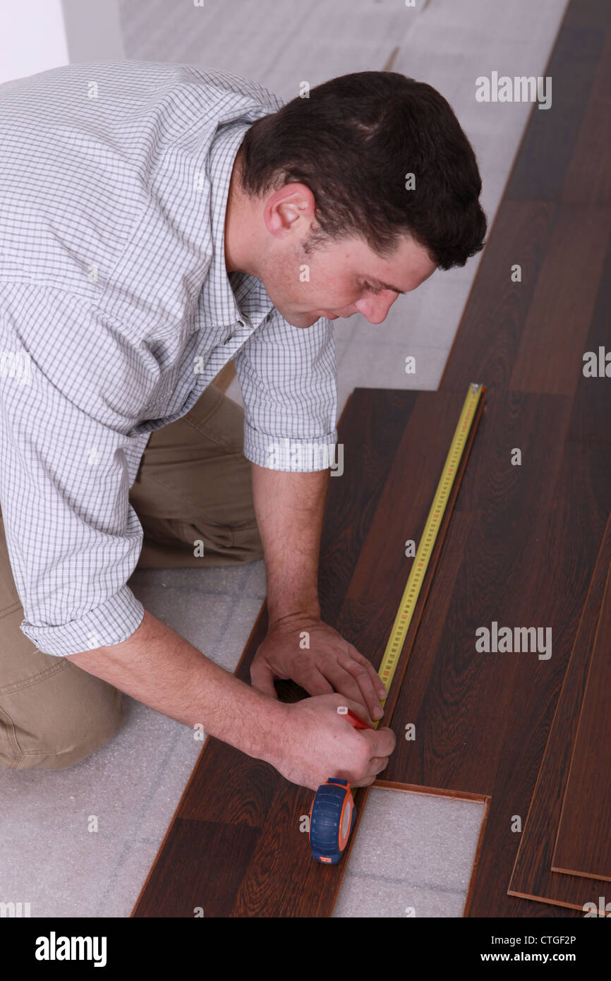 Man using a measuring tape Stock Photo - Alamy