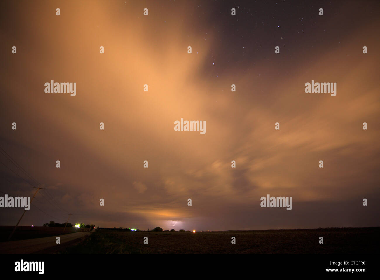 Small bolt of cloud lightning beneath a weak thunderstorm, with stars ...