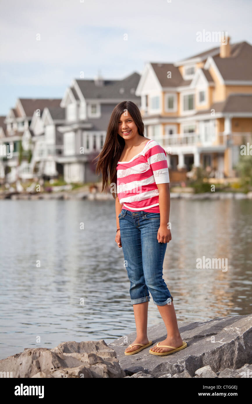 Teenage Girl On Lakeshore Of Residential Lake; Edmonton, Alberta ...