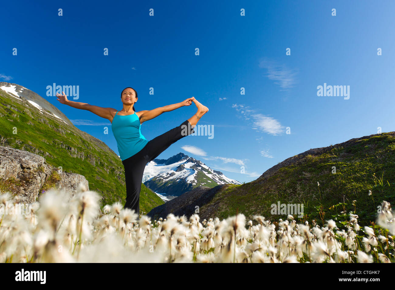 Korean woman practicing yoga with mountain in background Stock Photo ...