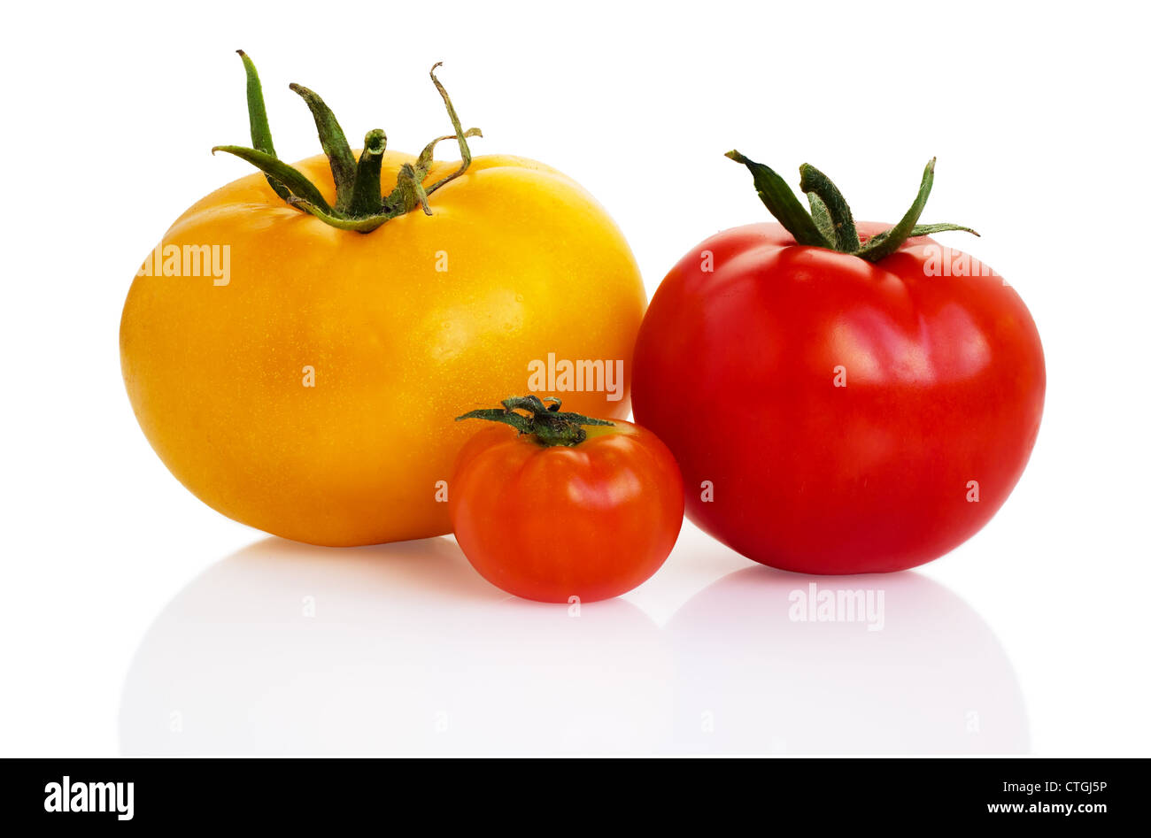 Three tomatoes of different colors and different sizes isolated on ...